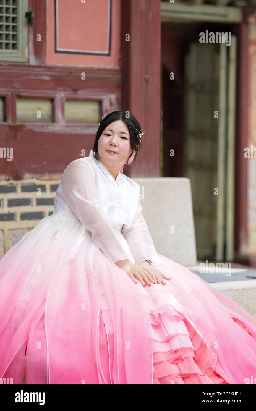 In June in Seoul, a Korean woman in her twenties sits beside a historic ...