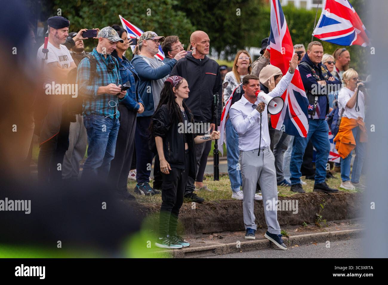 Altrincham, UK. 27 JUL, 2025. Prominent activist Ryan Ferguson shouts ...