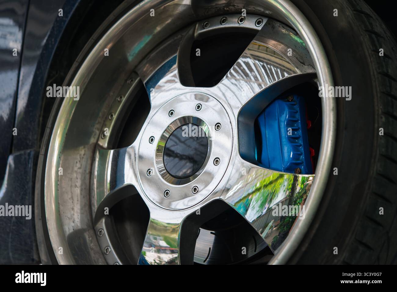 Car mechanic or serviceman disassembly and checking a disc brake and ...