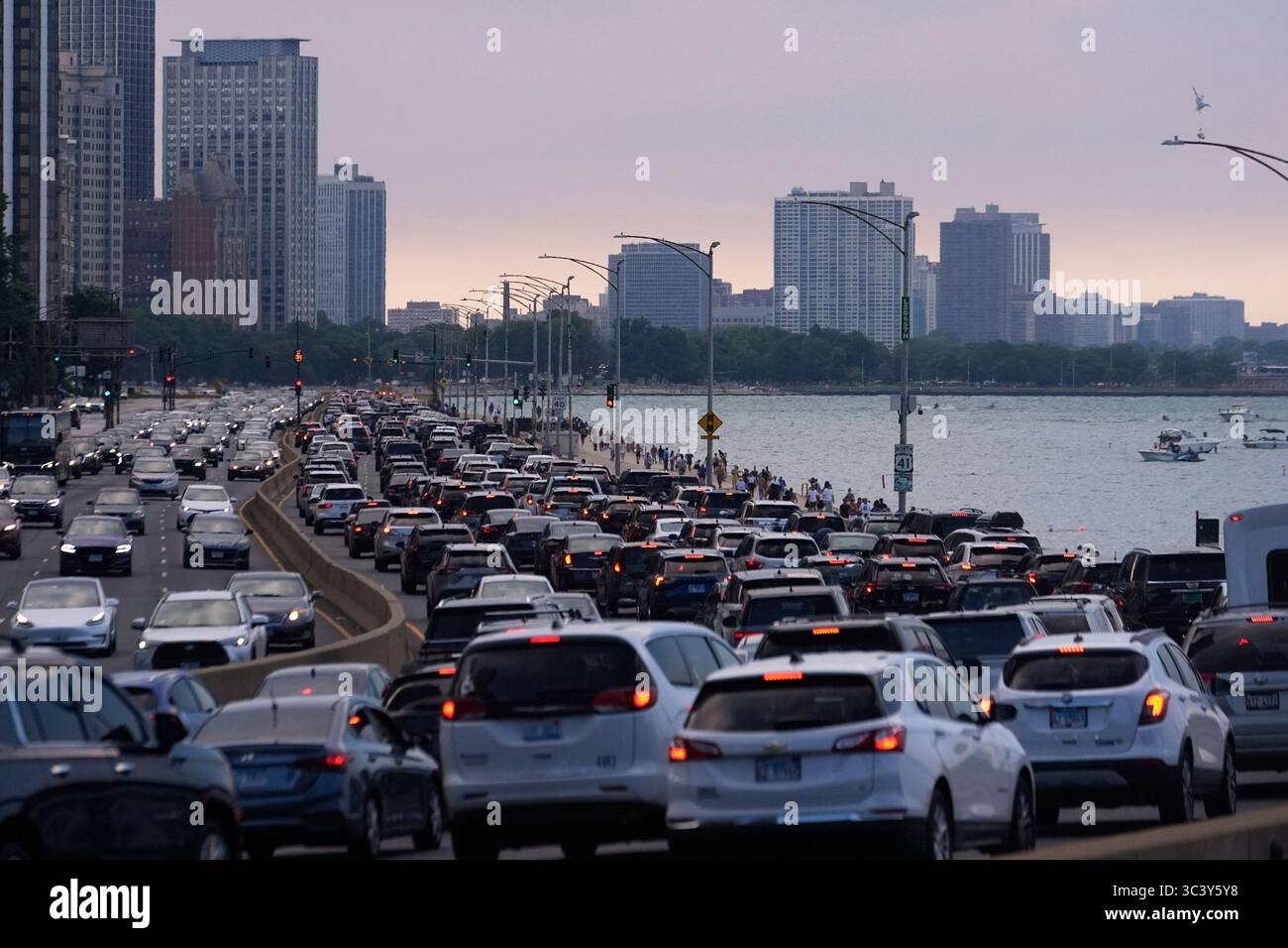 Congested traffic is seen as people gather on the shore of Lake ...