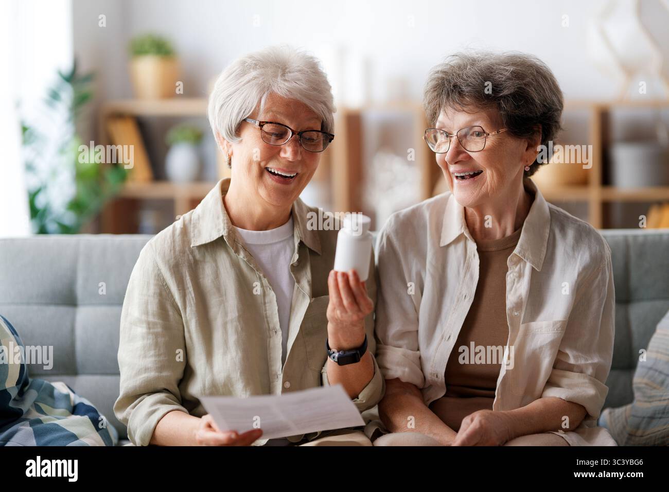 Two senior women are taking medication at home Stock Photo - Alamy