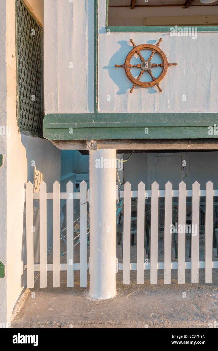 Maritime Beach House With Wooden Ship Wheel And White Picket Fence ...