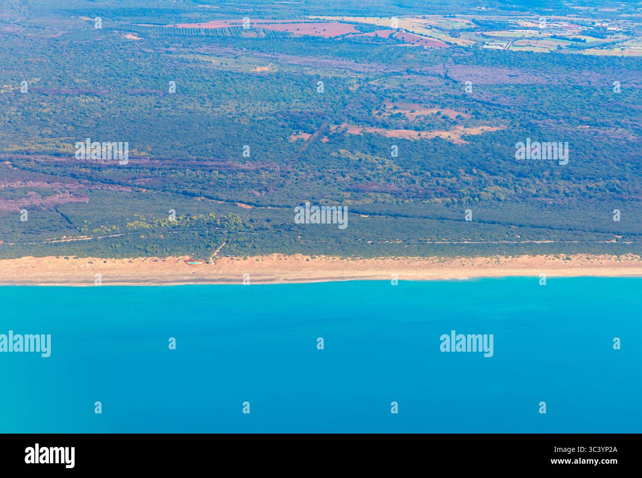 Coastal landscape showcasing vibrant turquoise sea meeting a sandy ...