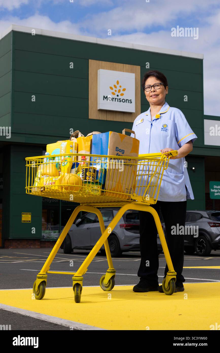 EDITORIAL USE ONLY Nurse Marlene Bayuga, with a trolley full of yellow ...