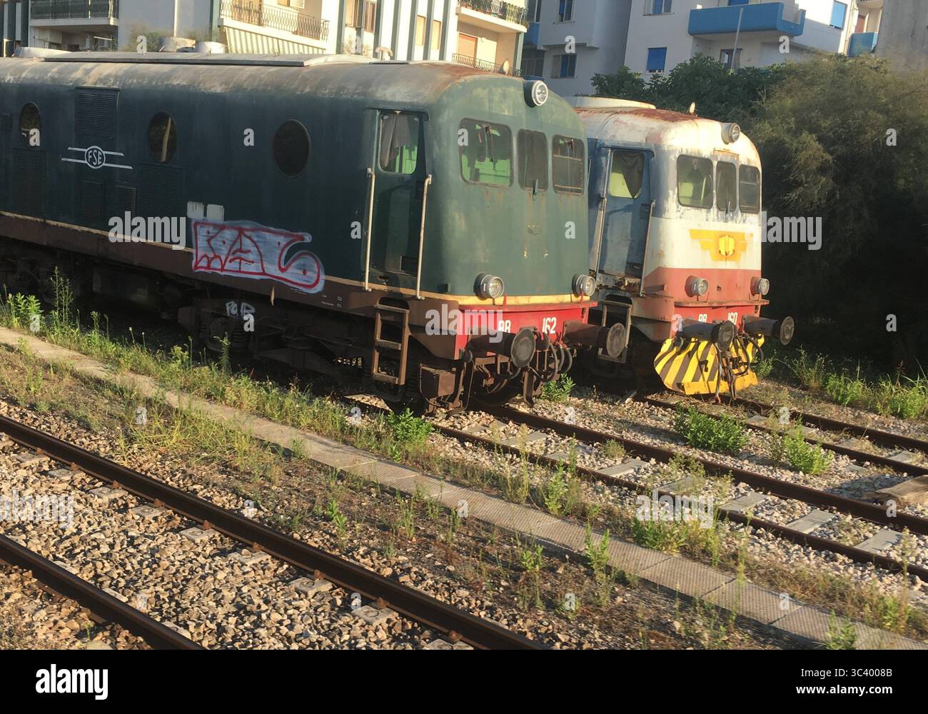 Colorful Italian passenger trains and railway wagons captured in motion ...