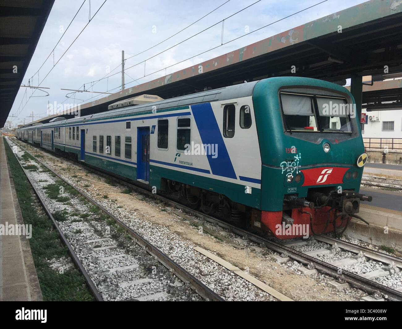 Colorful Italian passenger trains and railway wagons captured in motion ...