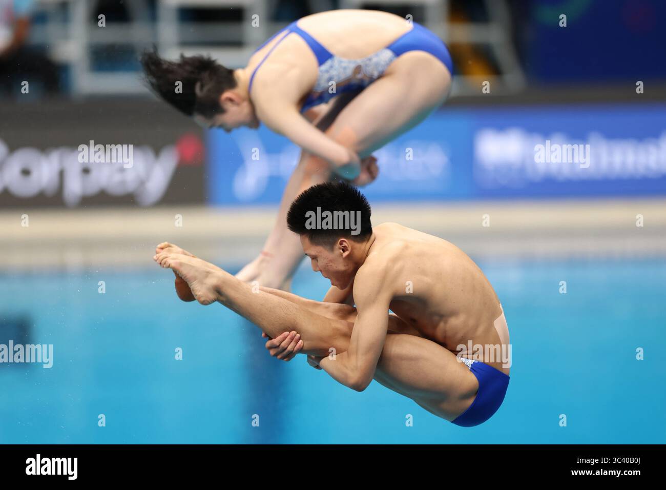 Chen Yiwen (top) and Cheng Zilong compete in the 3m springboard event ...