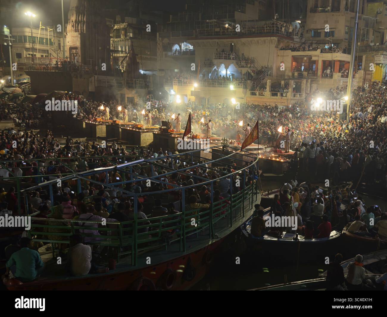 Crowd gathers on the river bank at night for a solemn ceremony with ...