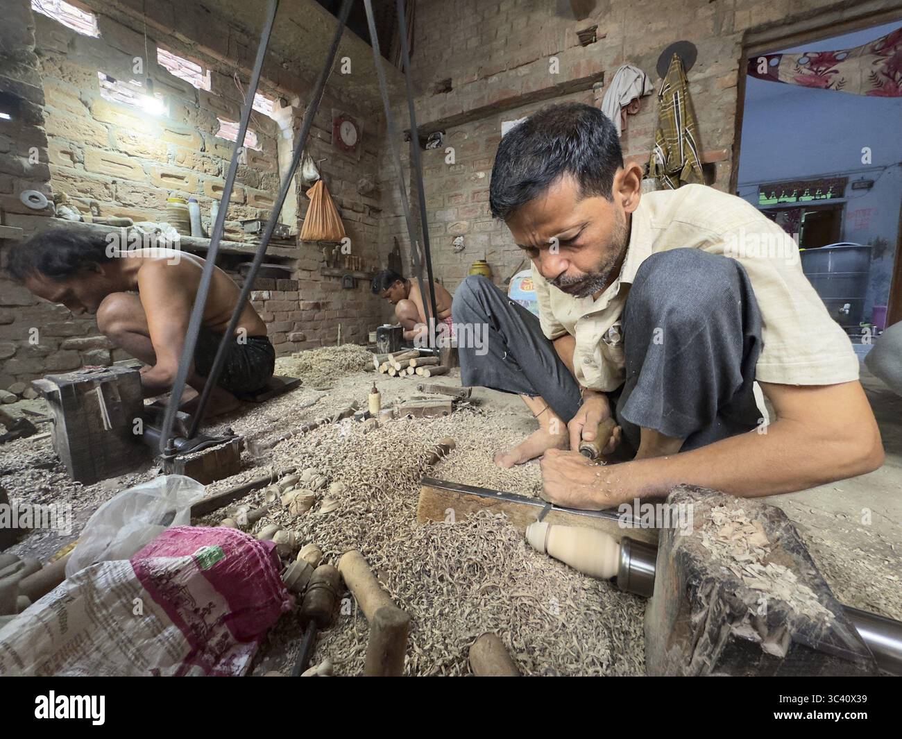 Men in a workshop using traditional woodworking techniques, Varanasi ...