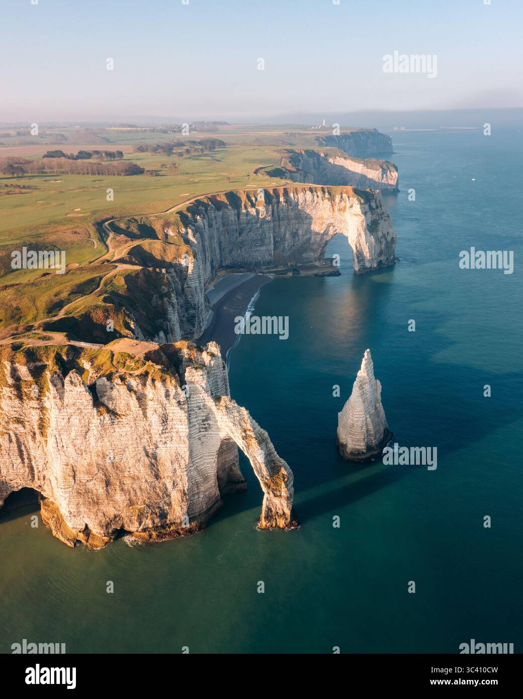 Aerial view of dramatic cliffs meet the turquoise sea, the iconic ...
