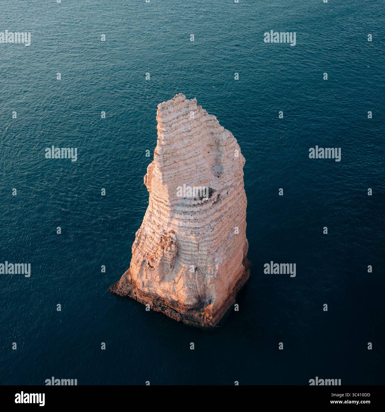 Aerial view of the solitary needle rock formation piercing the deep ...