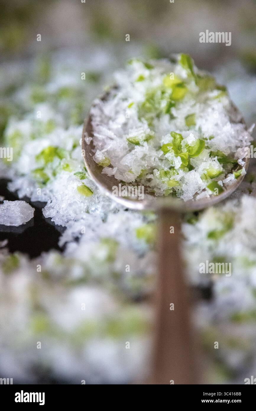 Vertical Closeup of Garlic Scape Finishing Salt in Spoon Stock Photo ...