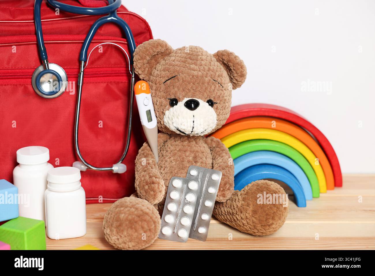 Pediatrician concept. Teddy bear, other toys, first aid, stethoscope ...