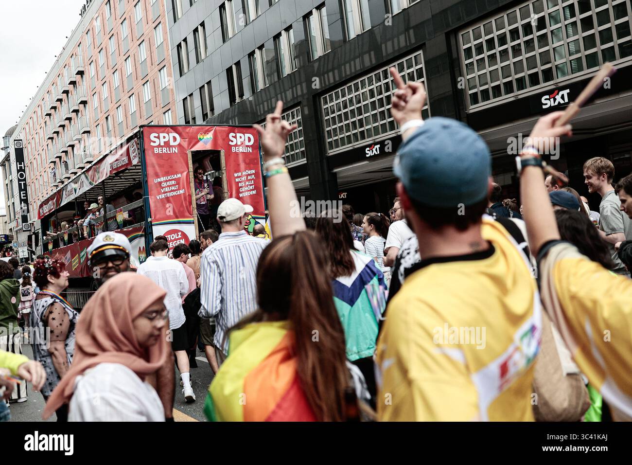 (EDITOR'S NOTE: Image depicts profanity) Parade attendees show middle ...