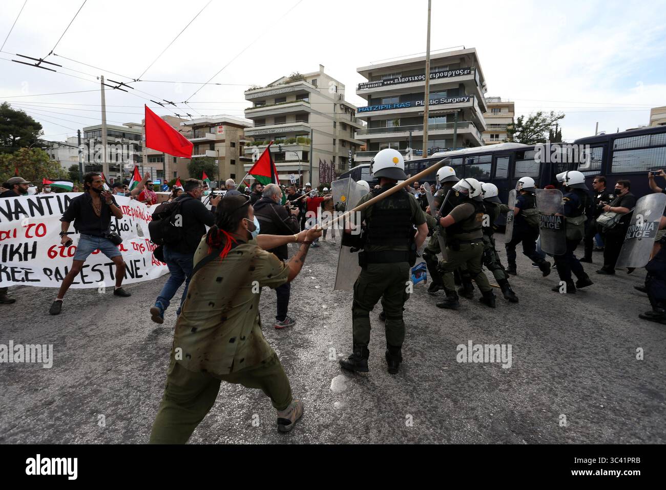 May 12, 2021, Athens, Greece: Protester hits riot police with a stick ...