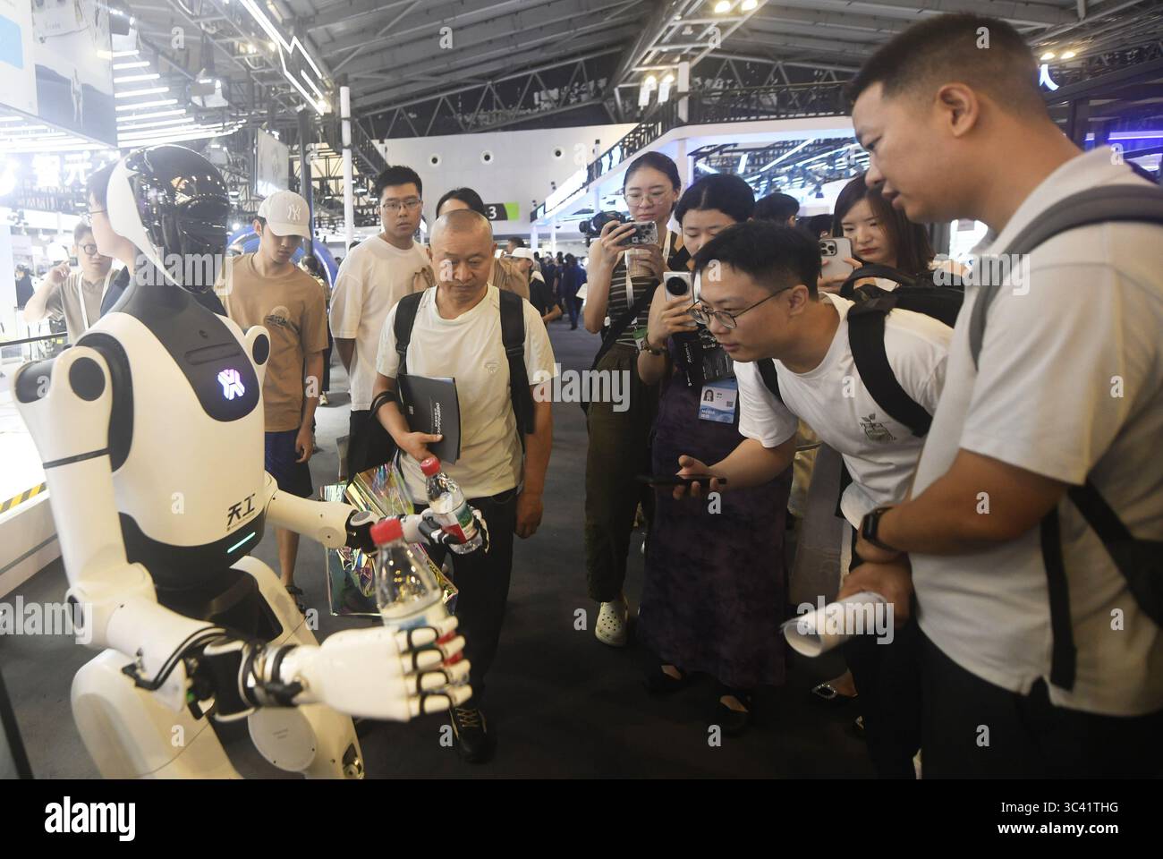 Audience watched a Tiangong humanoid robot fetching water for the ...