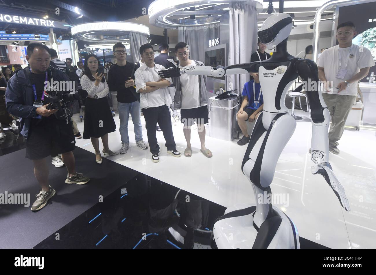 Audience watch an interactive performance of a Robot Era humanoid robot ...