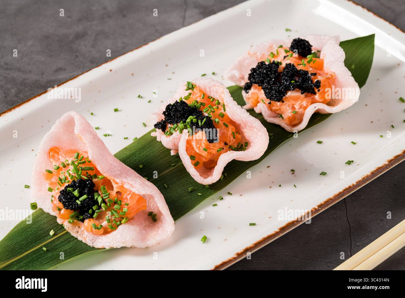 Tuna tartar with roe and caviar served on crispy crackers Stock Photo ...