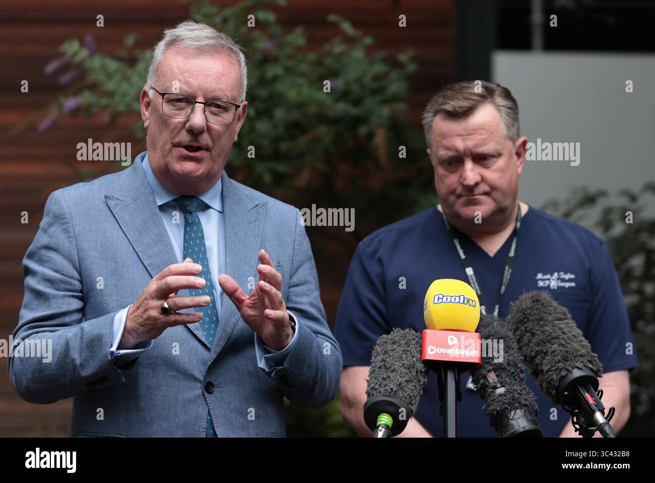 Health Minister Mike Nesbitt (left) speaking at a press conference at ...