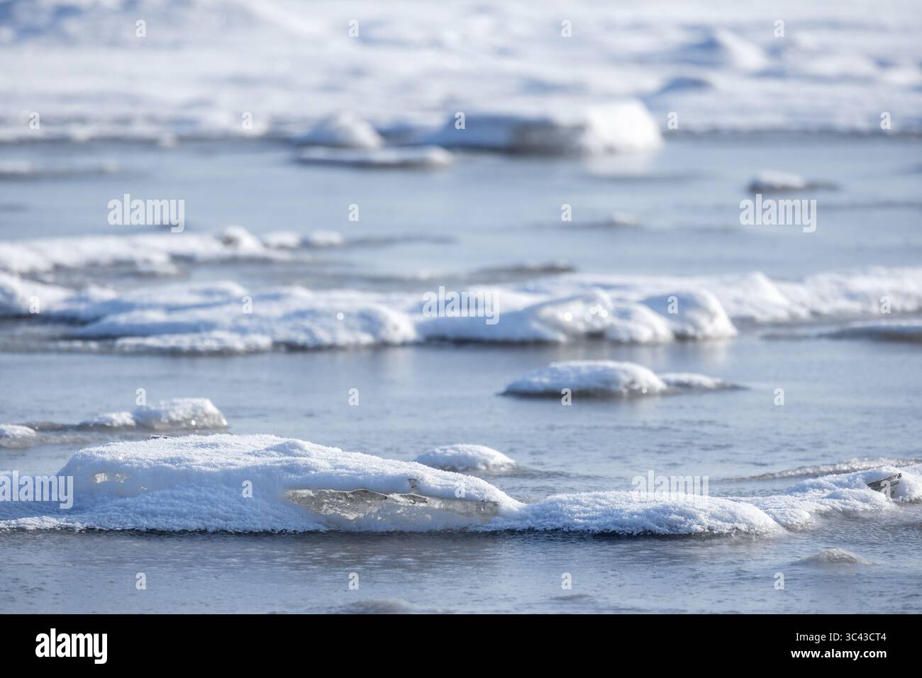 Scenic view of frozen landscapes with chunks of ice floating on a cold ...