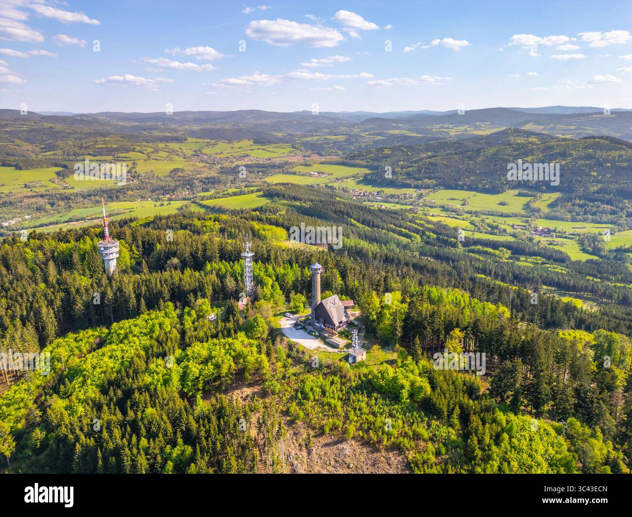 An aerial view captures the Svatobor Lookout Tower surrounded by lush ...