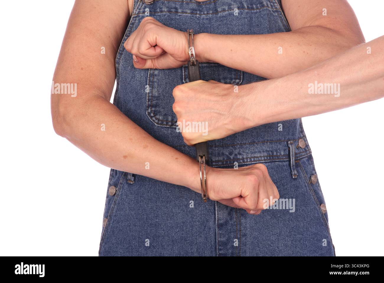 Woman in handcuffs and denim overalls Stock Photo - Alamy