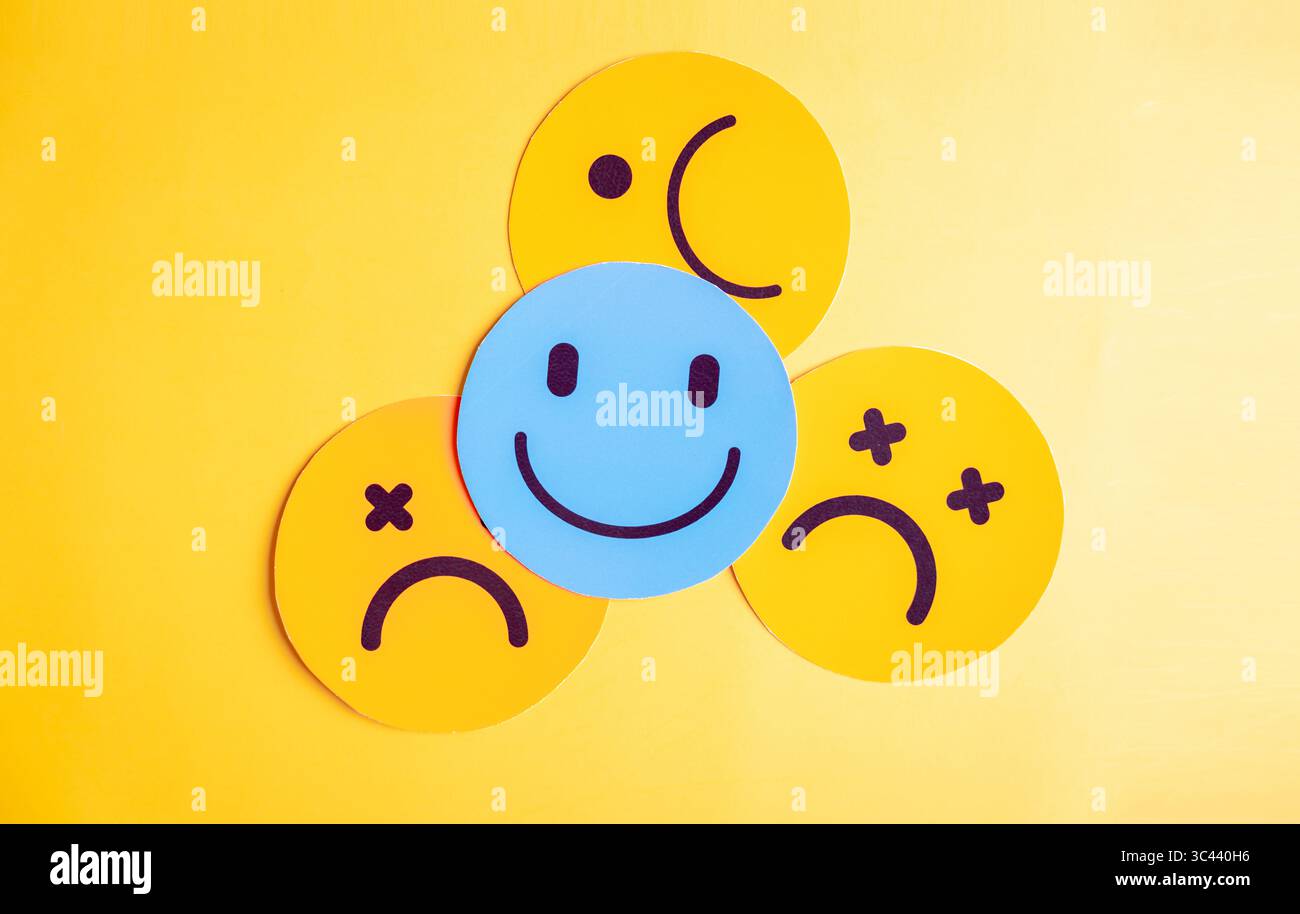 Emotional state and mental wellness. Smiley face by multiple sad ...