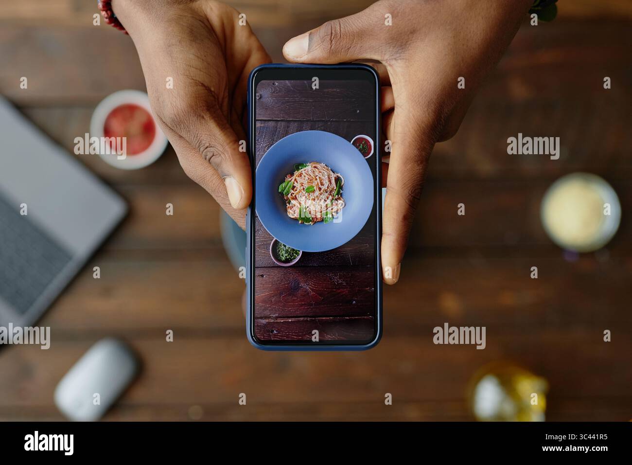 Person Photographing Pasta Dish with Smartphone over Wooden Table Stock ...