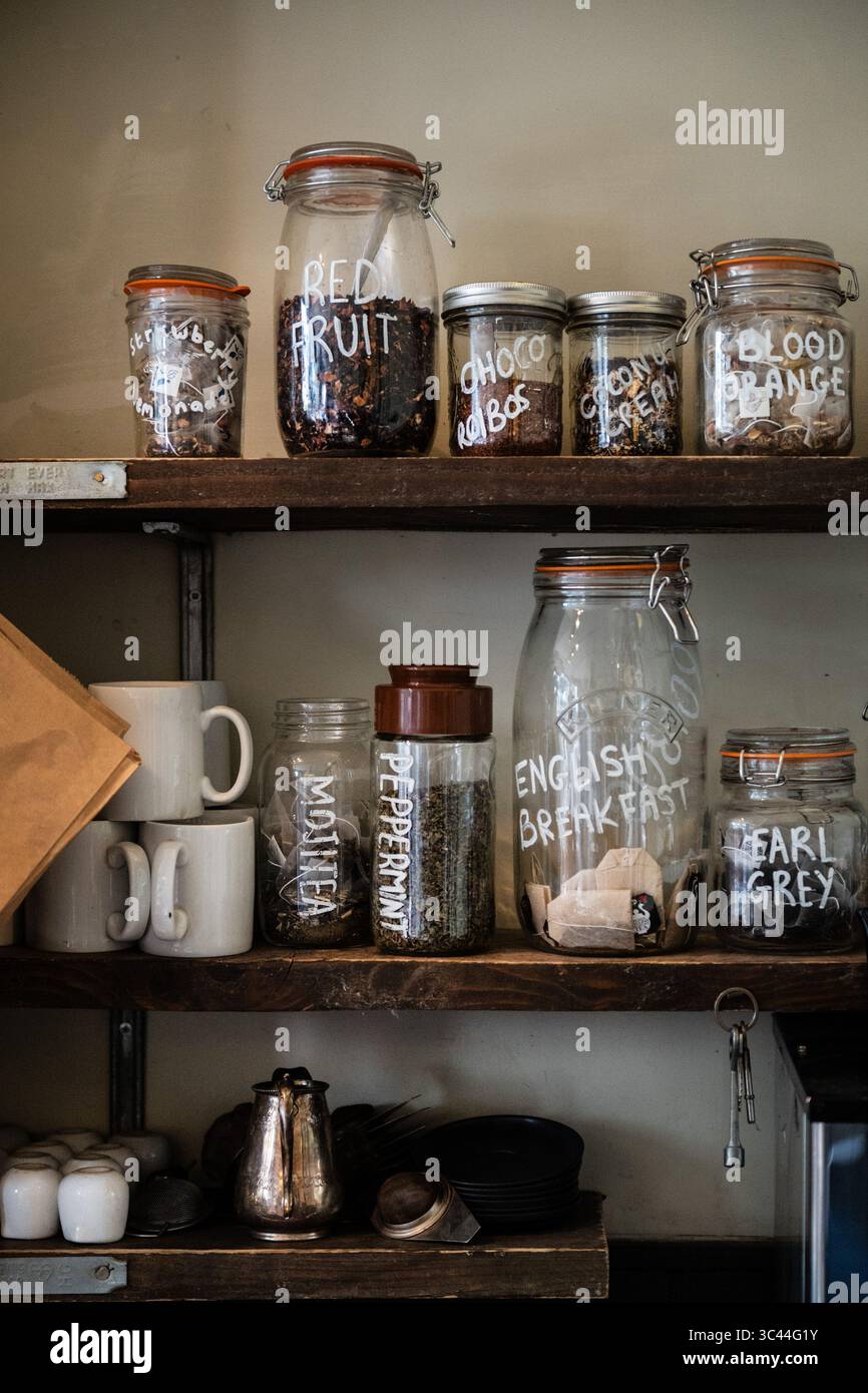 Close-up of rustic wooden kitchen shelves filled with glass jars ...