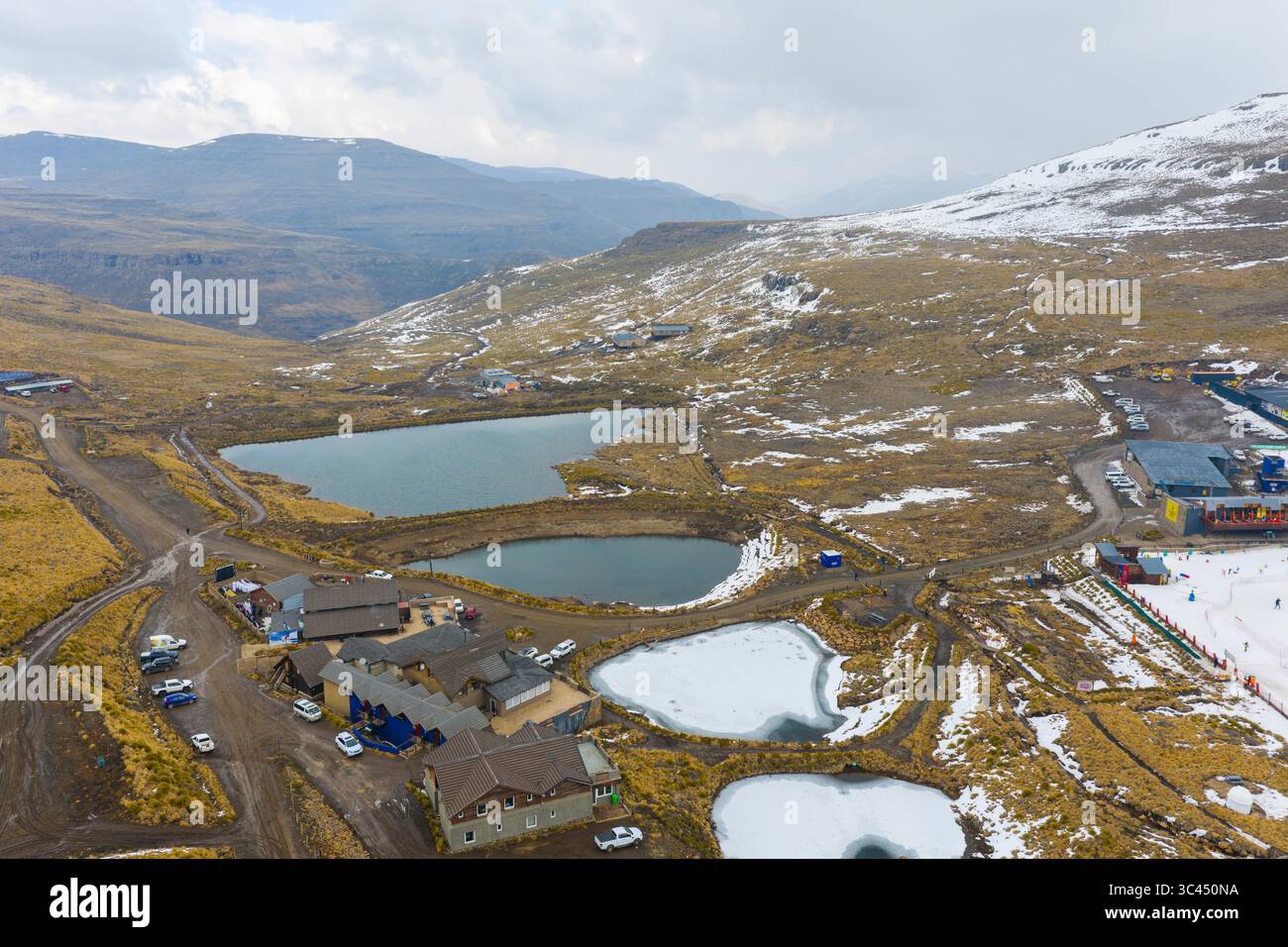 Aerial view of reflective lakes mirroring the sky, nestled amidst snow ...