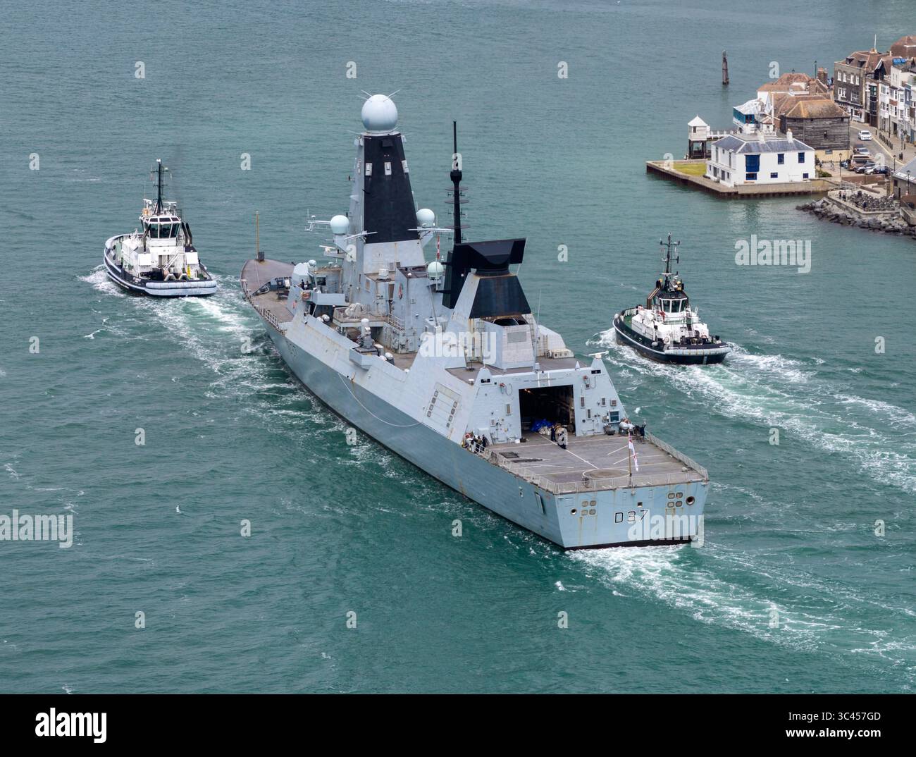 The Royal Navy (RN) Type 45 destroyer HMS Duncan (D37) assisted into ...
