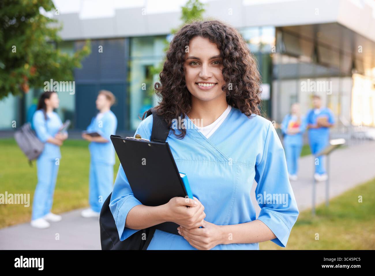 Medical student in uniform with backpack, clipboard and notebook ...