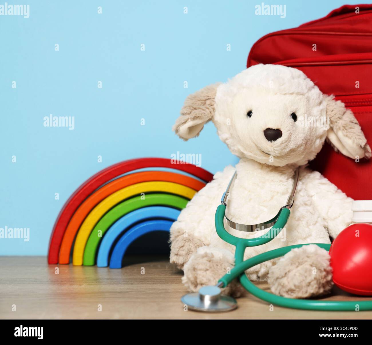 Pediatrician concept. Toys, stethoscope and first aid kit on wooden ...