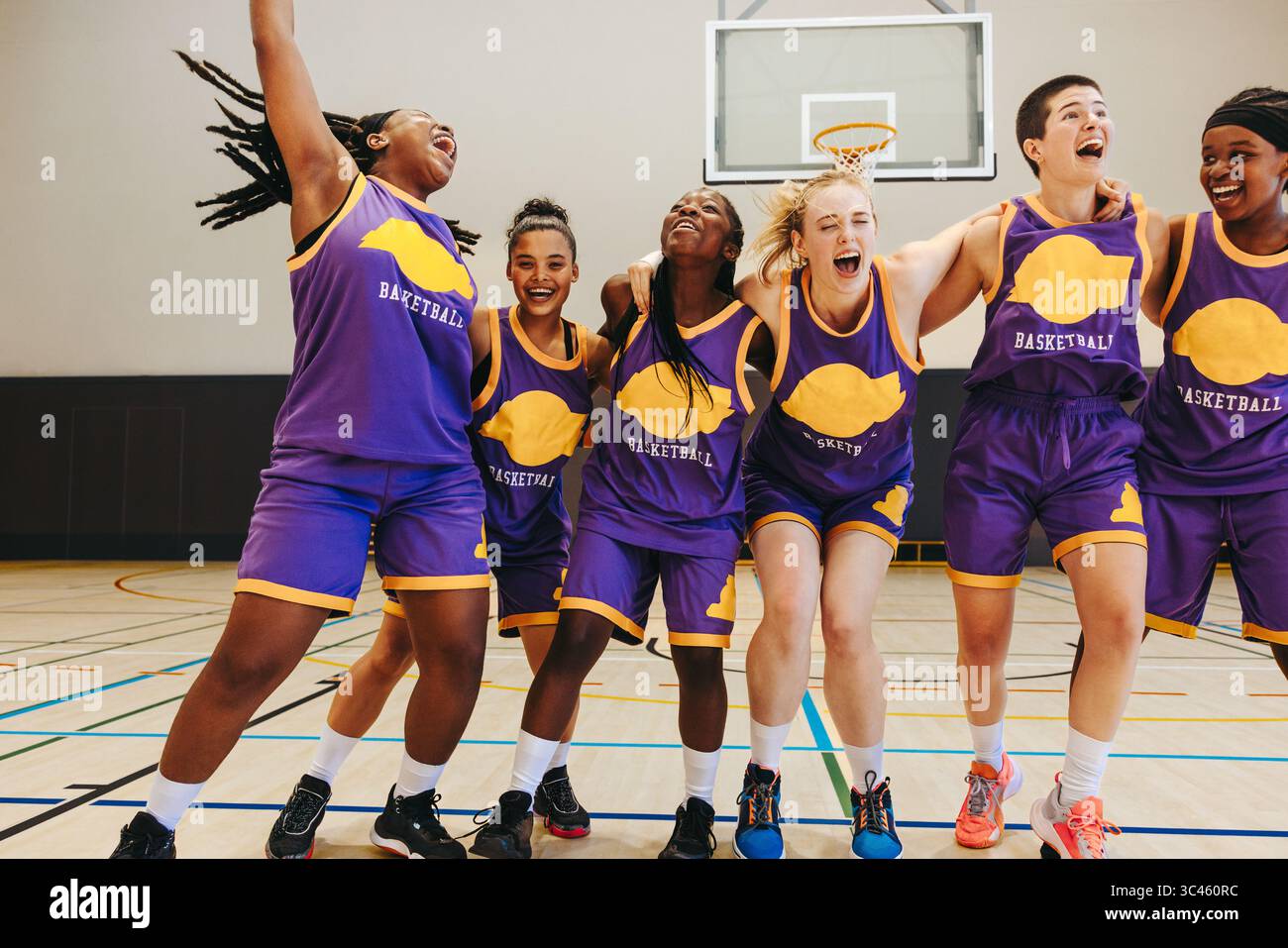 A group of young female basketball players celebrate victory on the ...
