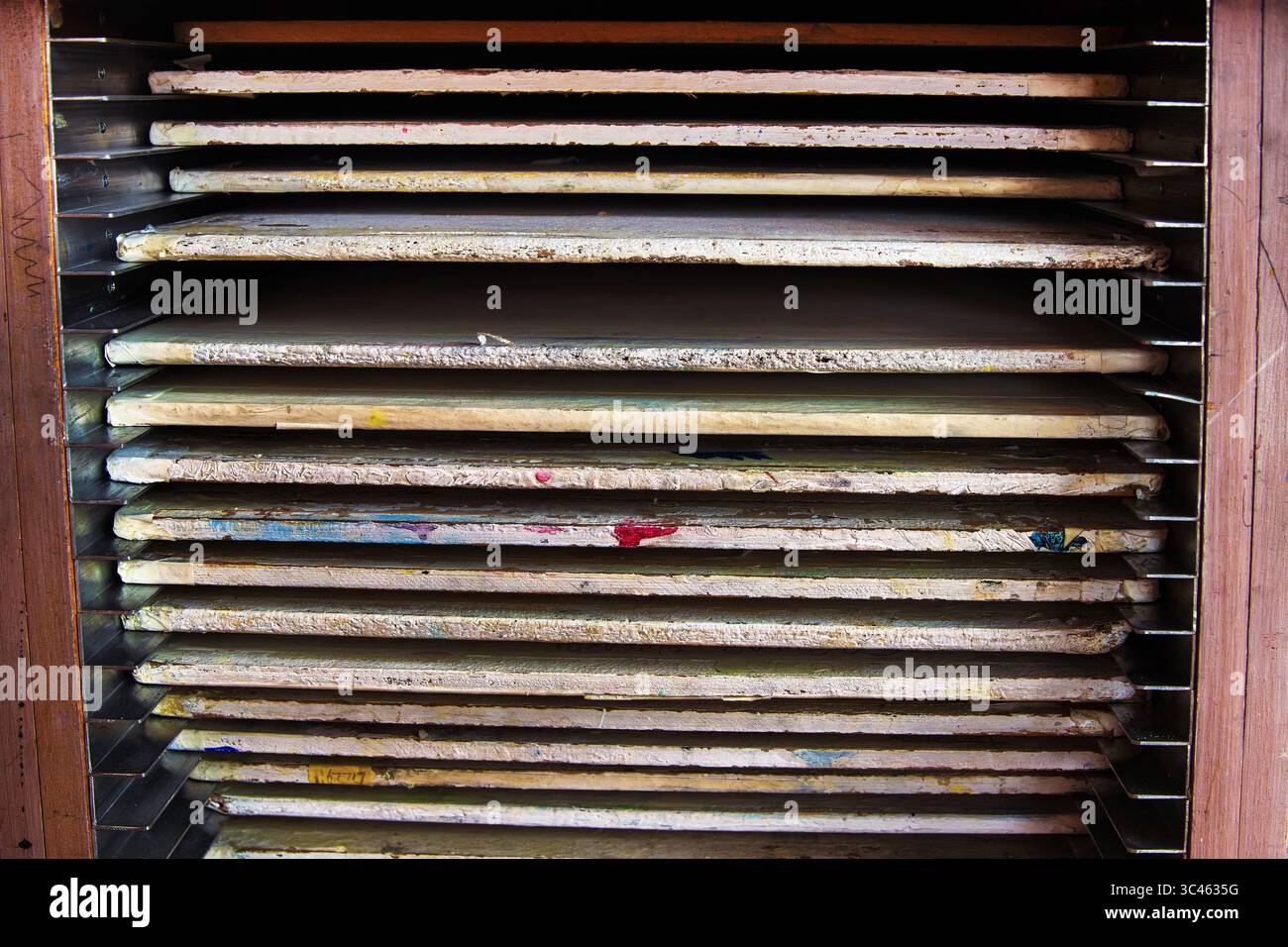A closeup of wooden drying racks with evenly spaced horizontal trays ...