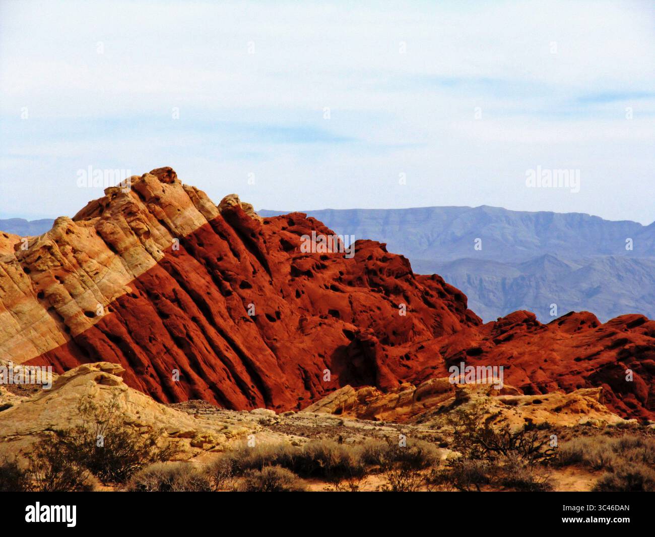 Sharp contact between vivid red sandstone and buff limestone in an ...