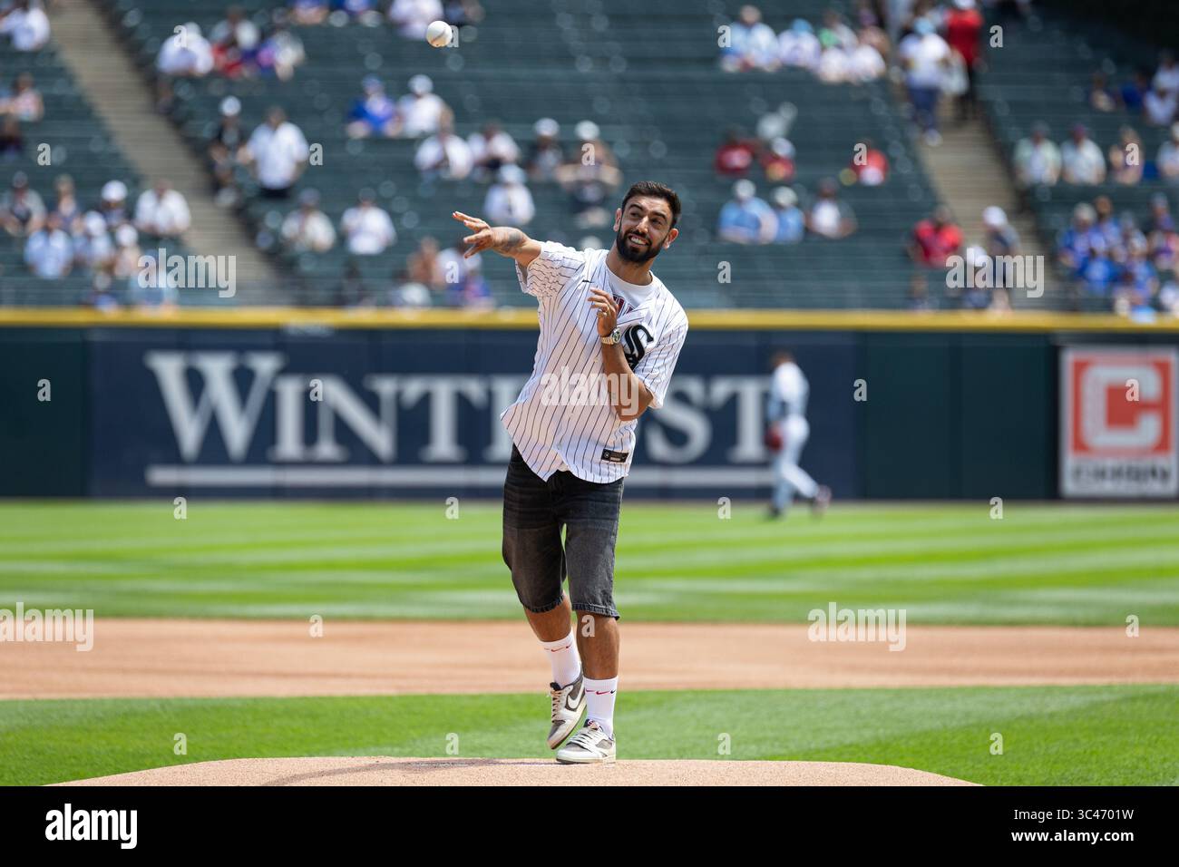 A fan throws the first pitch before the MLB regular season game versus ...