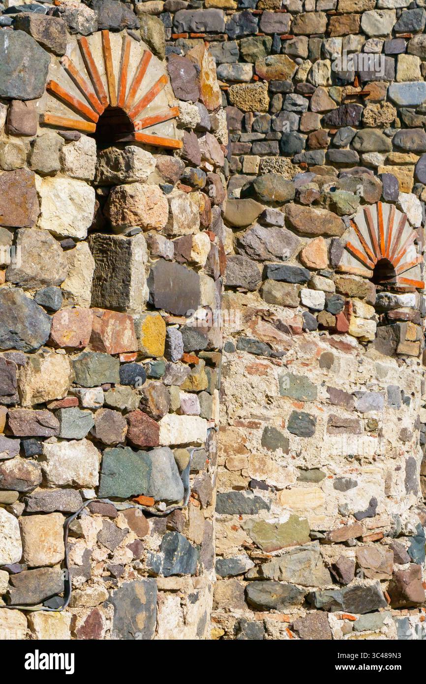 Detailed view of an old stone wall from a medieval fortress with red ...
