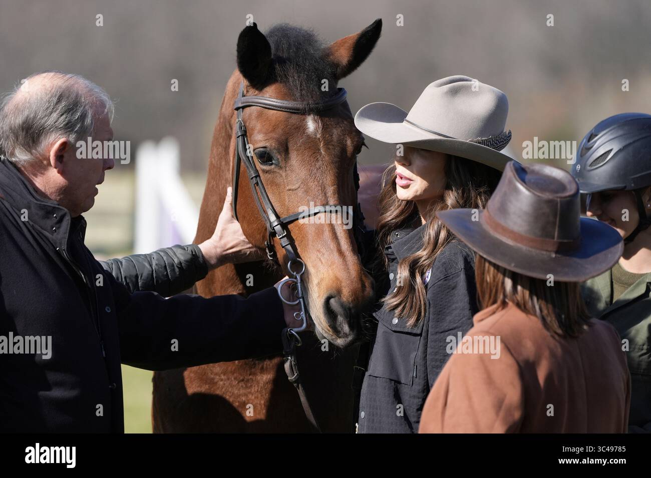 U.S. Homeland Security Secretary Kristi Noem, right, picks out a horse ...