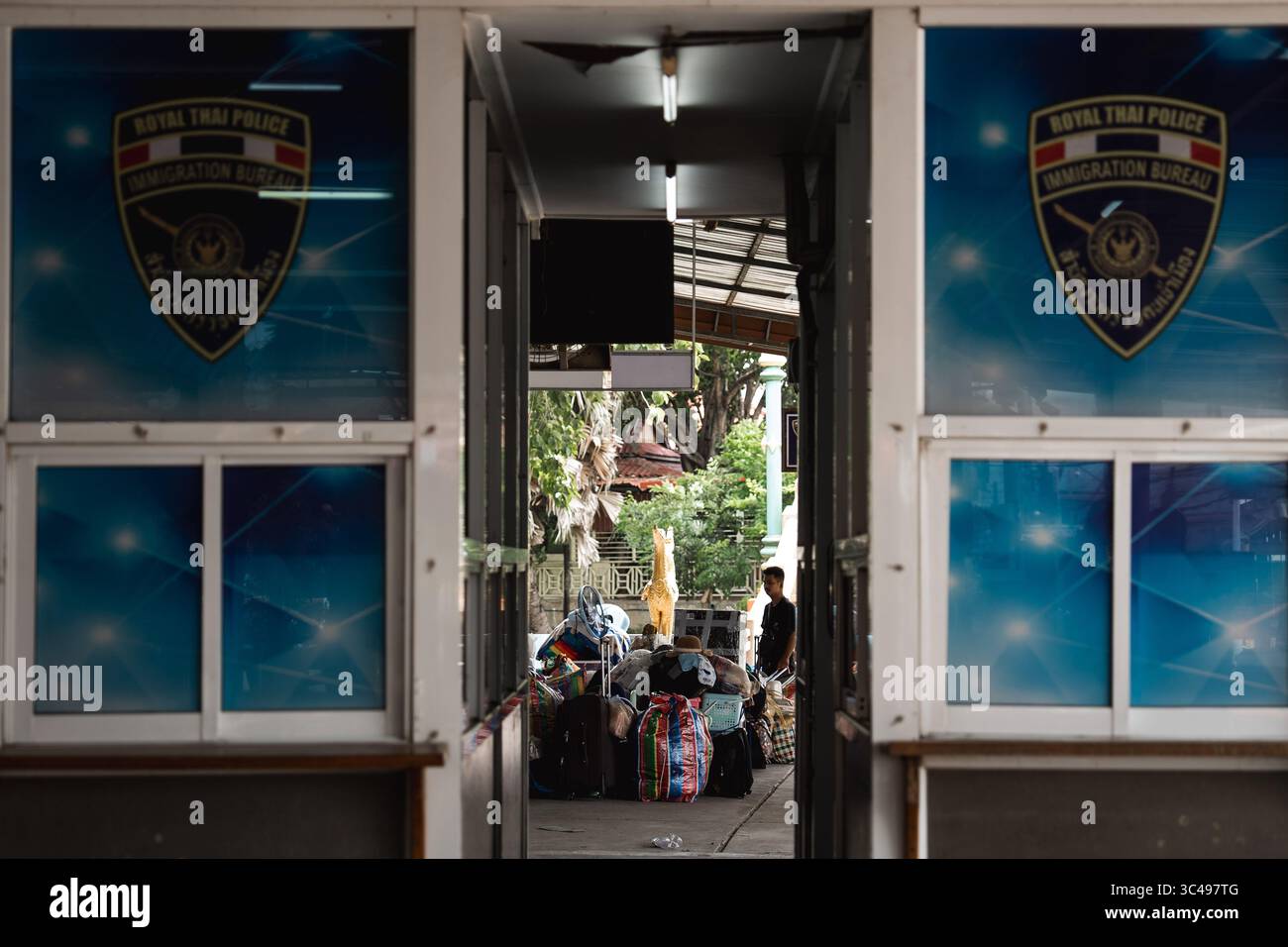 A pile of belongings and a stuffed llama seen behind the checkpoint of ...