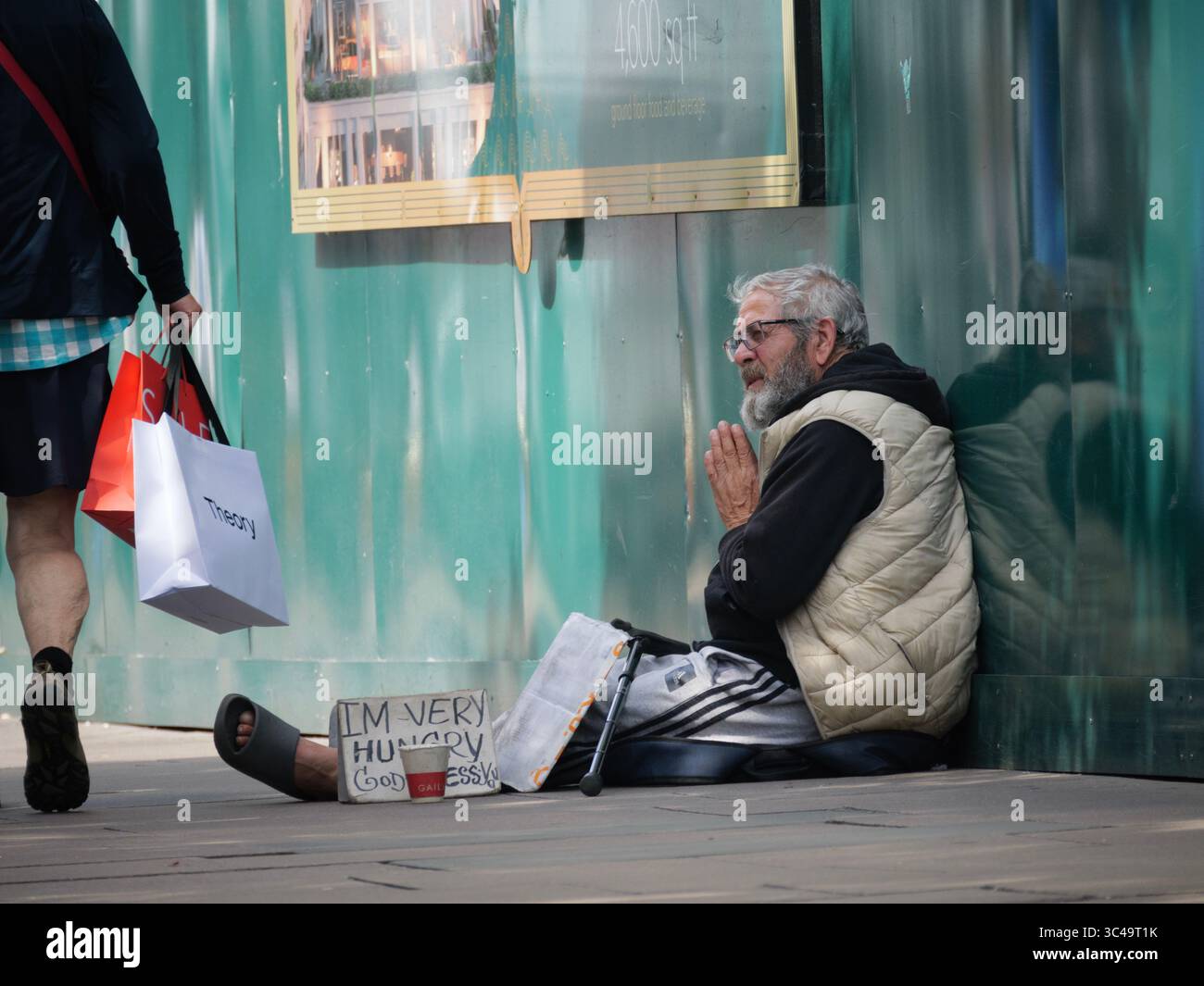 Homeless man sits on street hi-res stock photography and images - Alamy