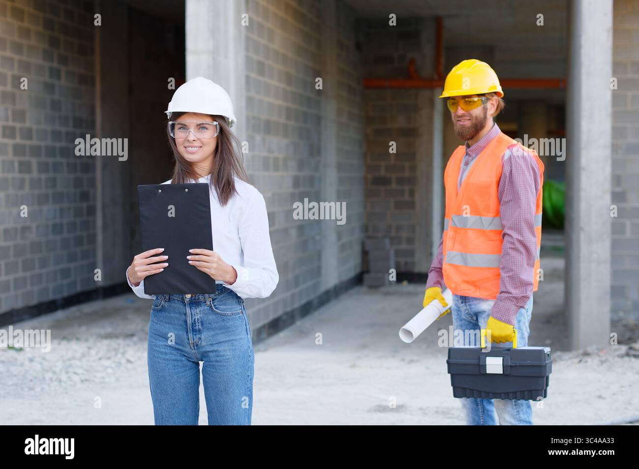 Diverse construction team in safety gear discussing project at ...
