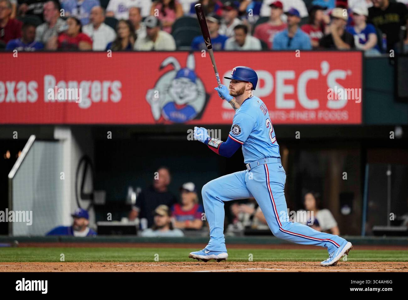 Texas Rangers' Jonah Heim follows through on a swing during a baseball ...