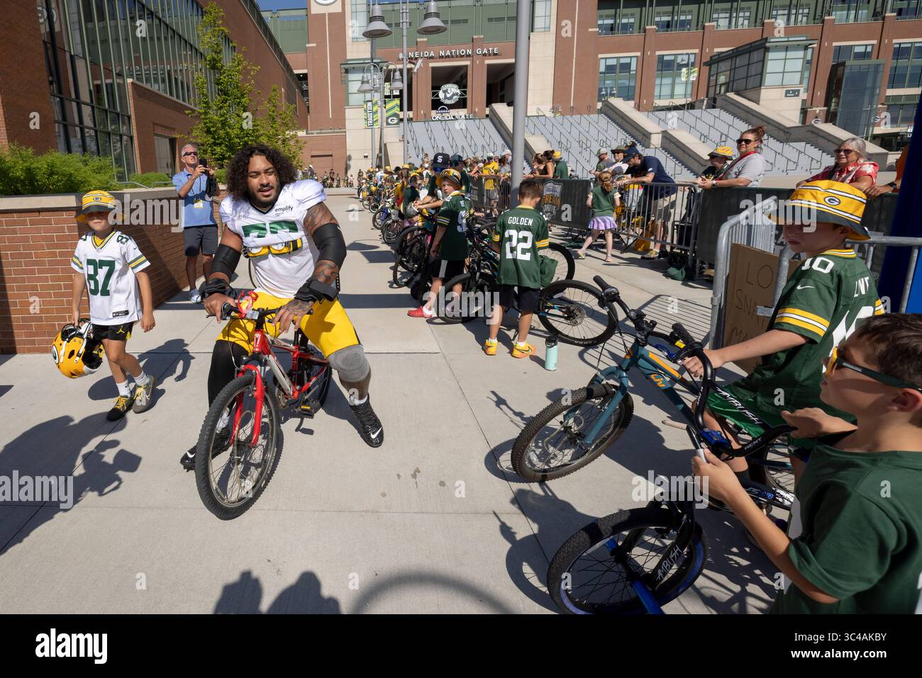 Green Bay Packers offensive tackle Jordan Morgan (77) rides a bike to ...