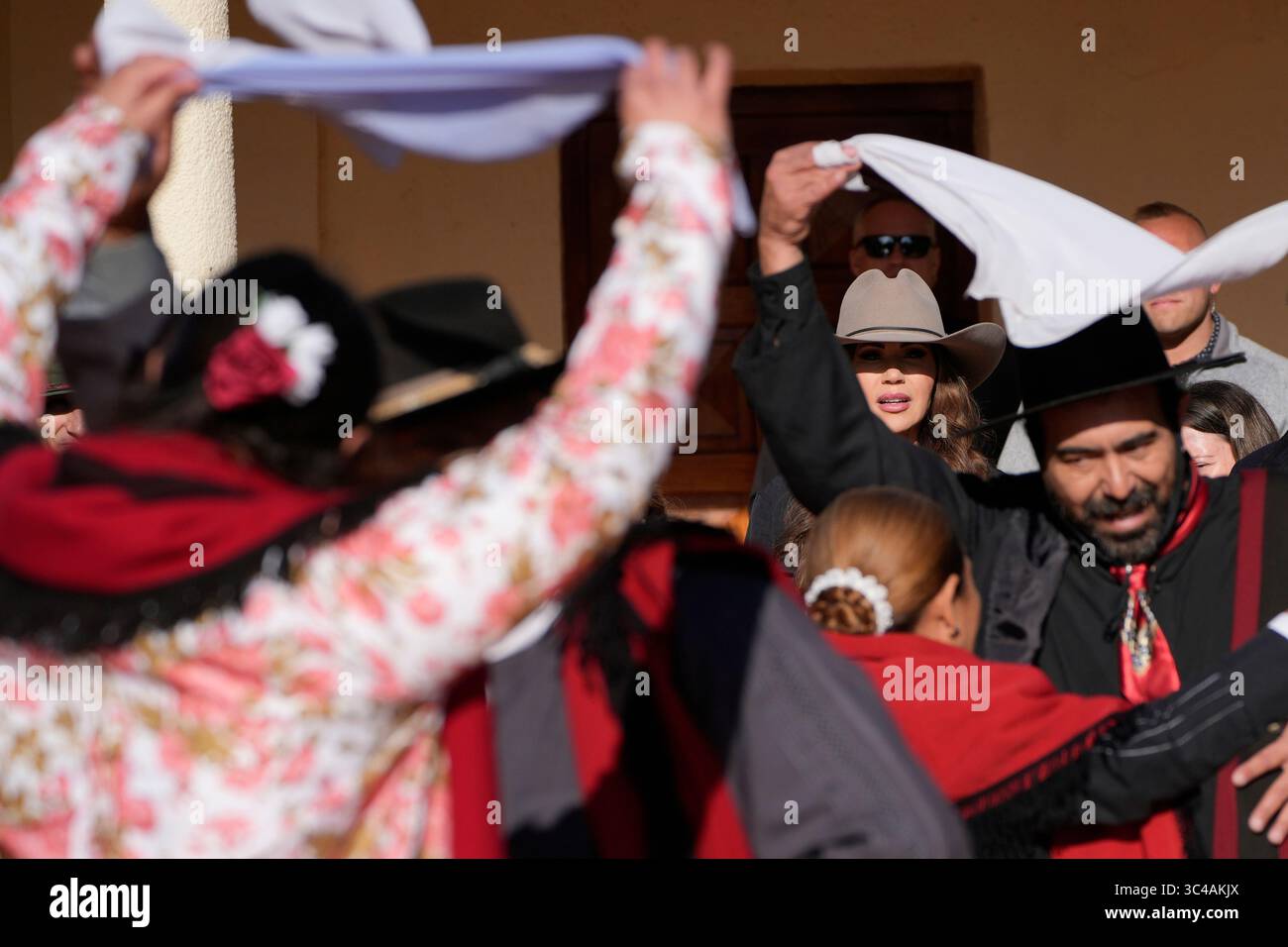 U.S. Homeland Security Secretary Kristi Noem, behind right, watches a ...