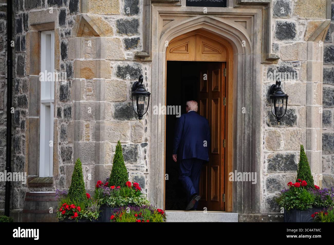 US President Donald Trump walks into MacLeod House as he arrives at ...