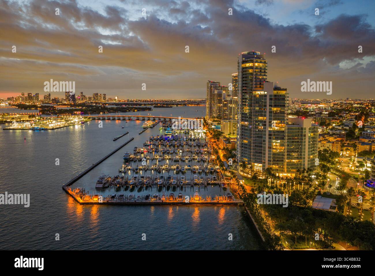 Twilight over Miami skyline and marina. Luxury yachts glowing in the ...