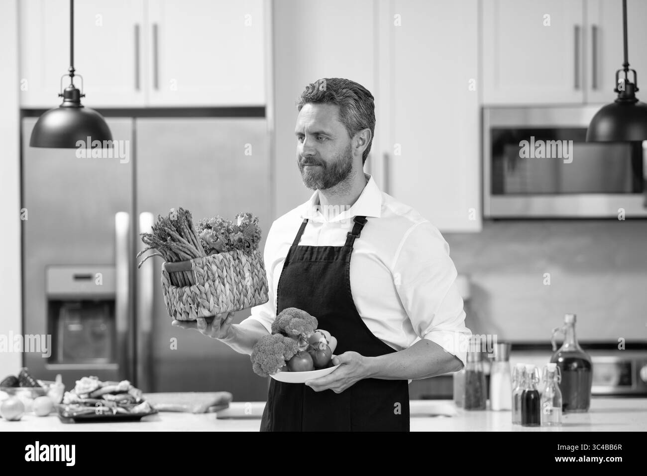 Hispanic man cooking home healthy food in apron choose ingredient for ...
