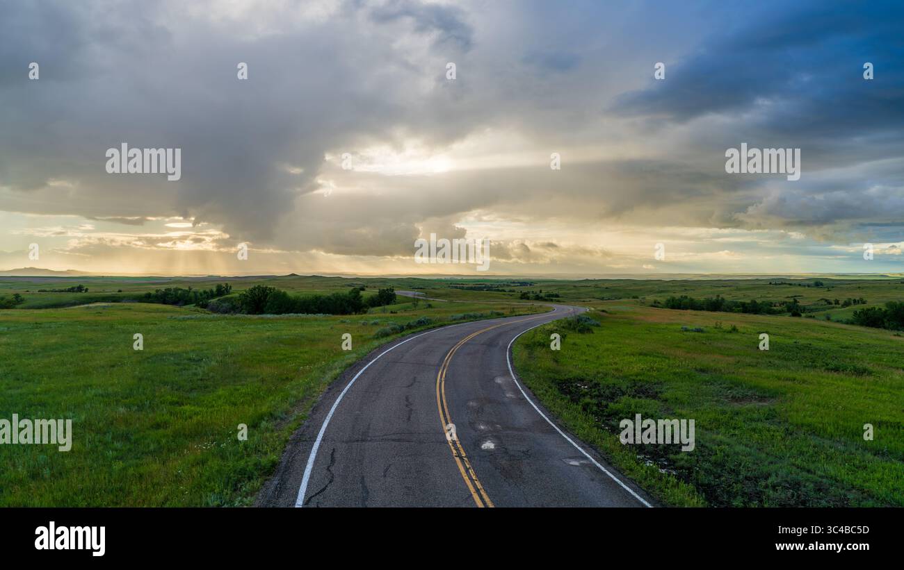 A prairie road trip at sunset illuminates the landscape of Theodore ...