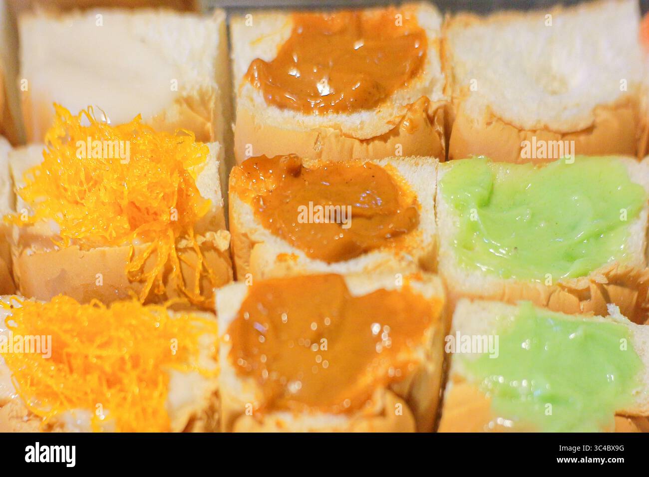 Steamed Thai dessert buns with creamy Thai tea custard and golden foi ...